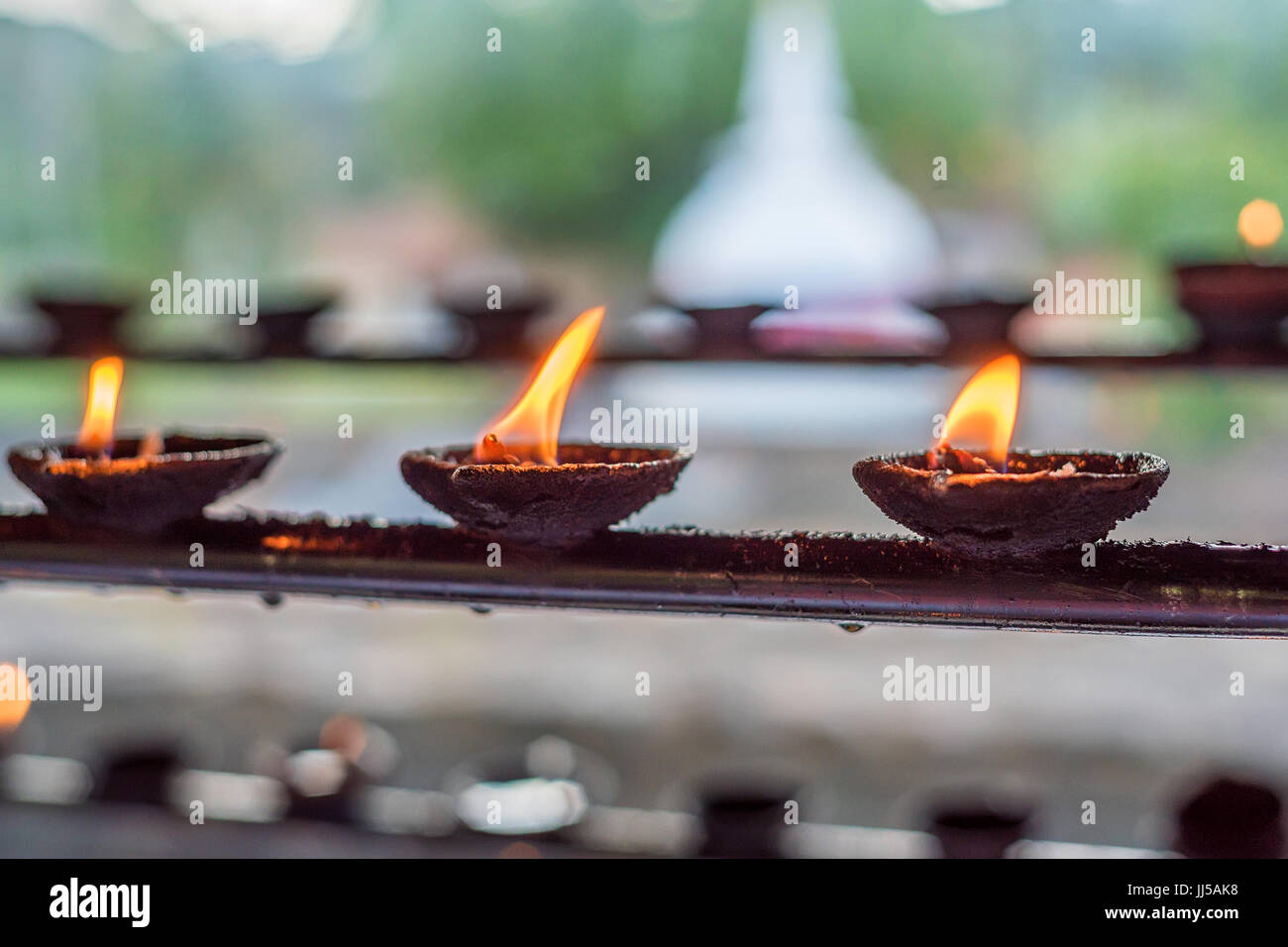Coconut oil lamps in temple Stock Photo - Alamy