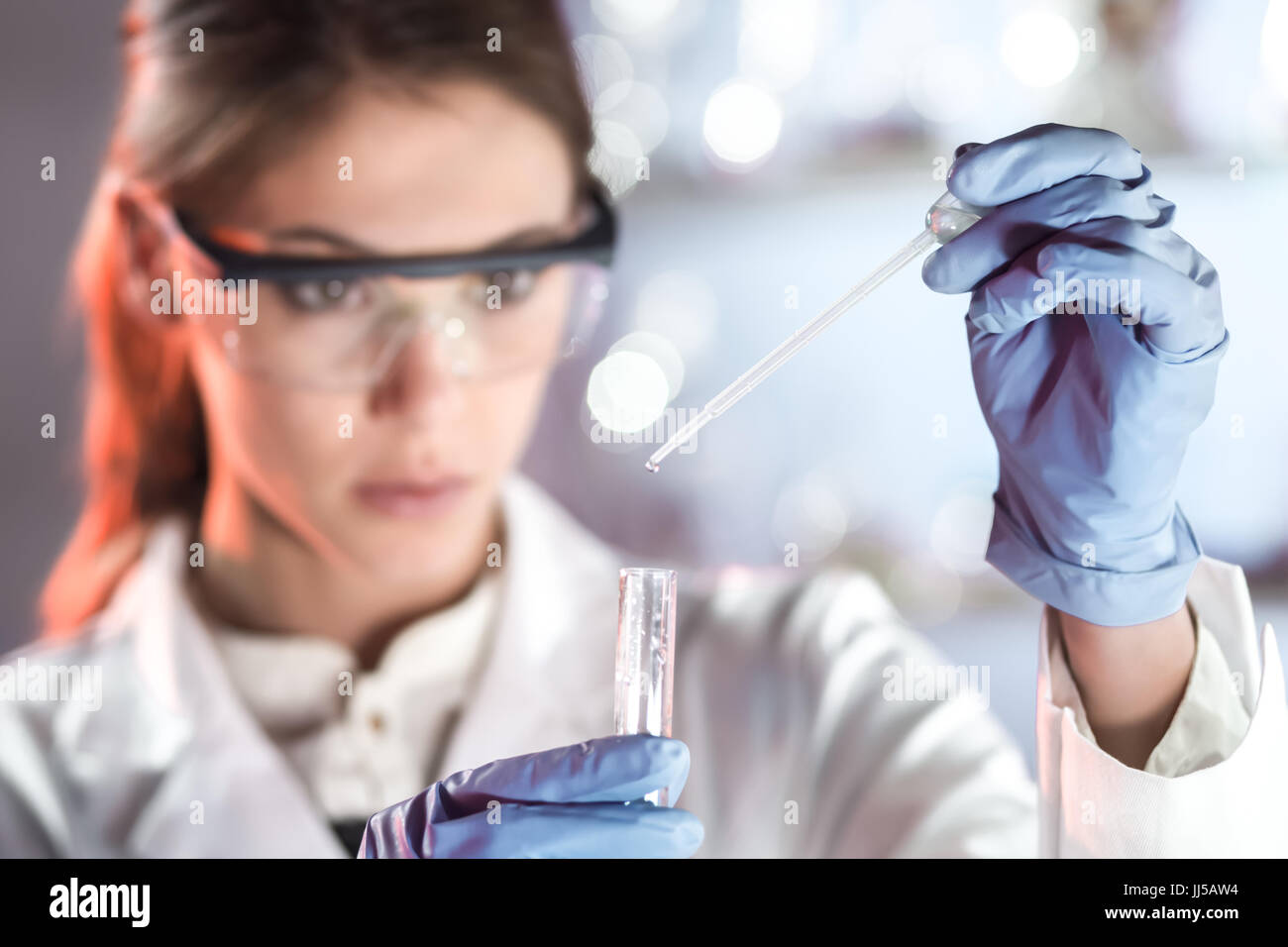 Young scientist pipetting in life science laboratory Stock Photo - Alamy