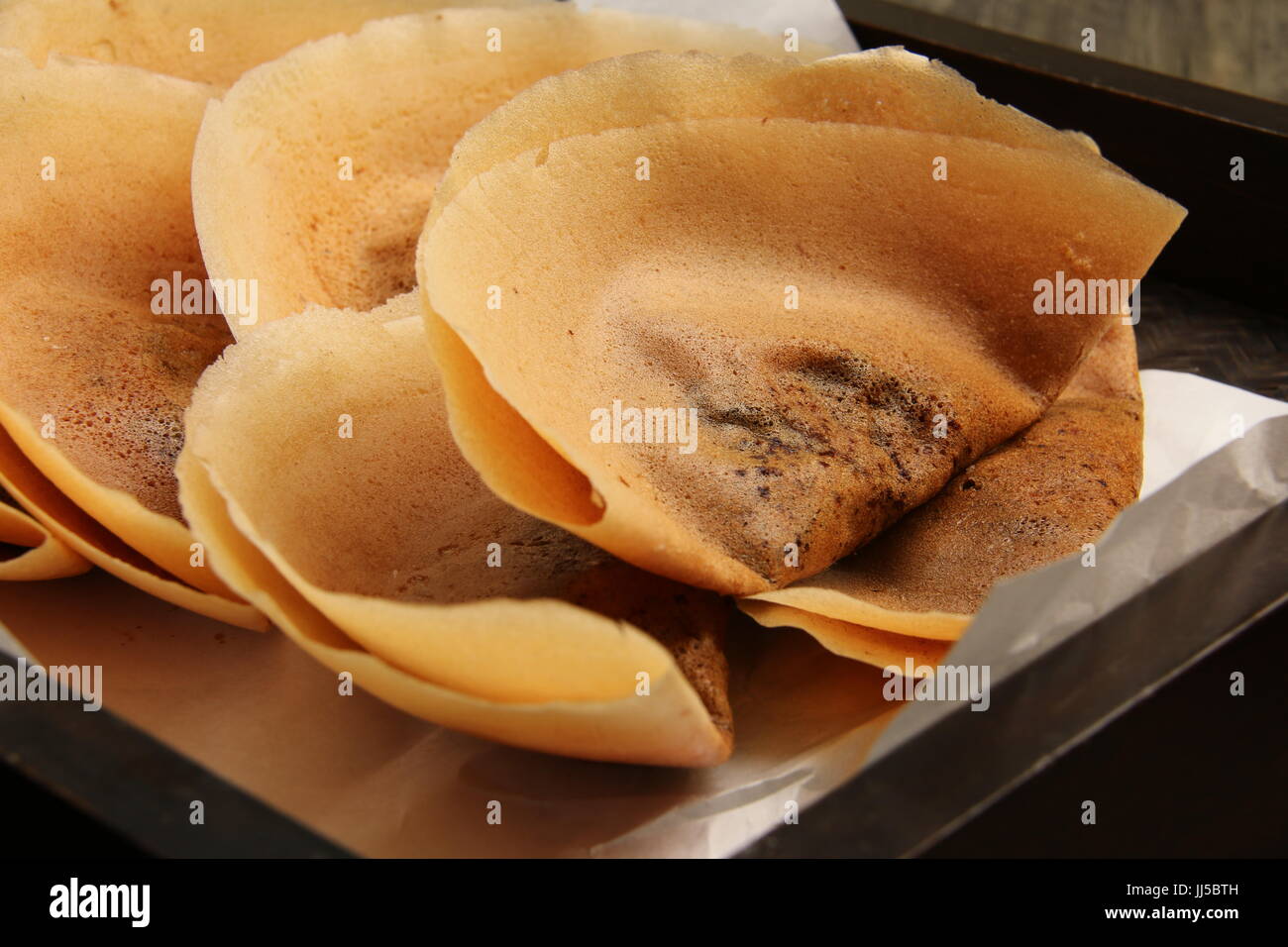 Kue Lekker, Indonesian street food of thin, crispy pancakes with banana ...