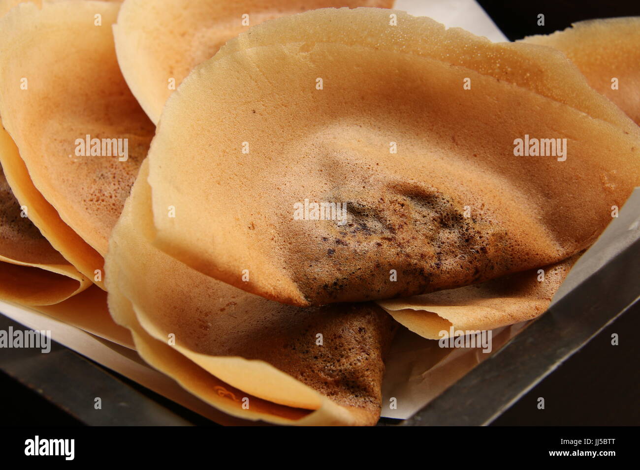Kue Lekker, Indonesian street food of thin, crispy pancakes with banana ...