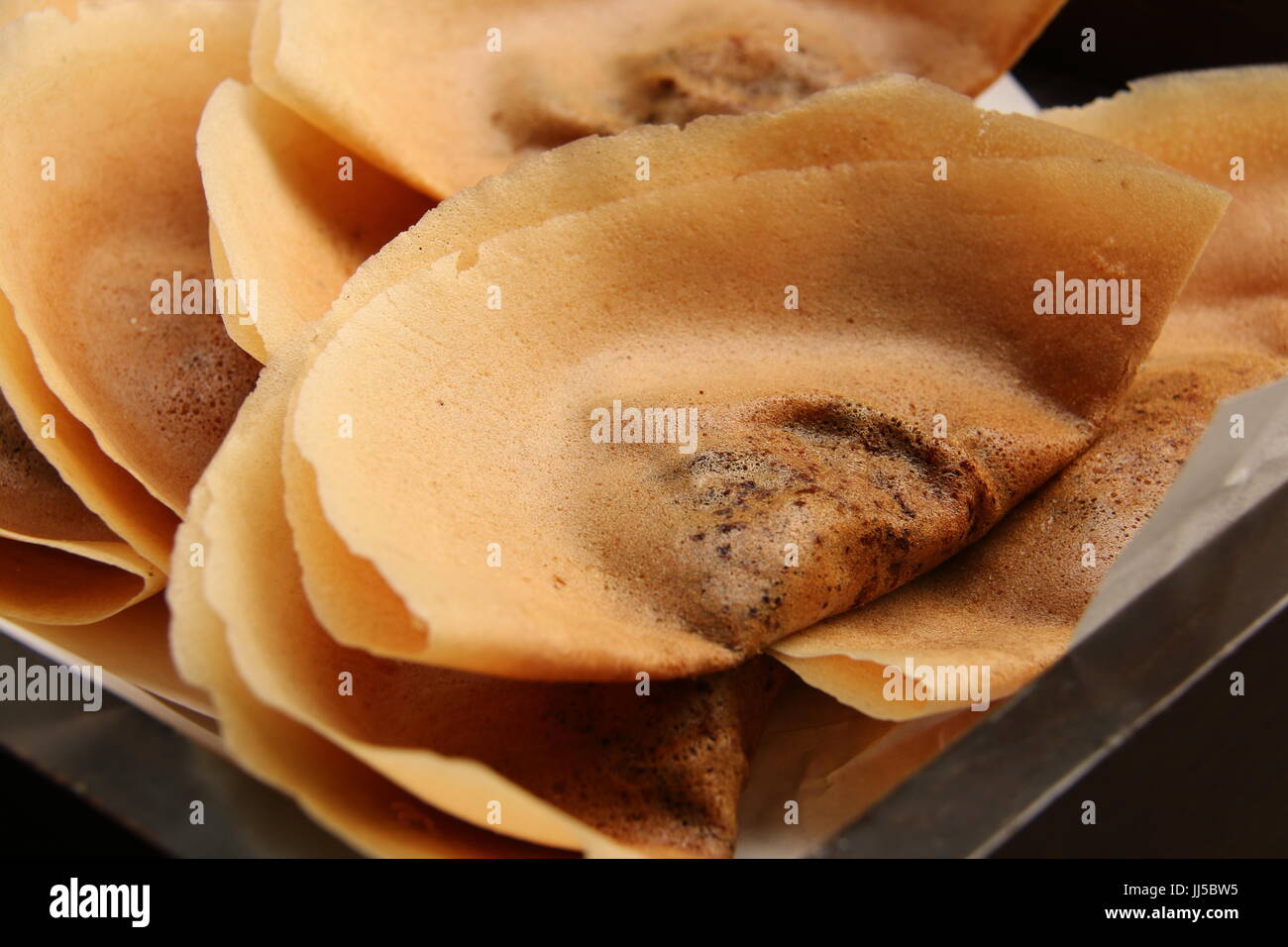 Kue Lekker, Indonesian street food of thin, crispy pancakes with banana ...