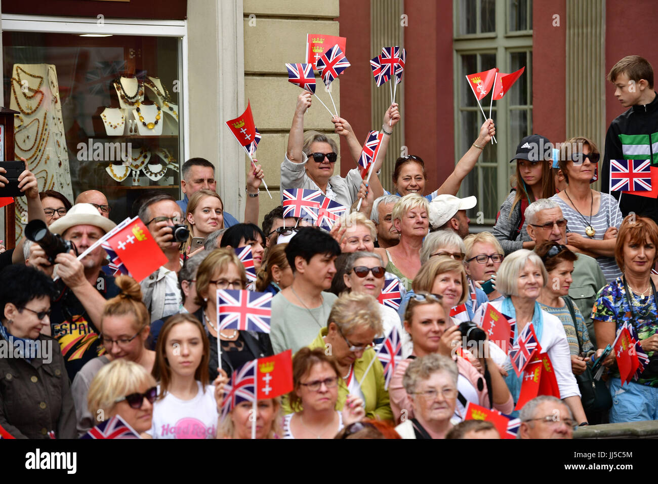 People hold Union flags as crowds gather ahead of the arrival of the ...