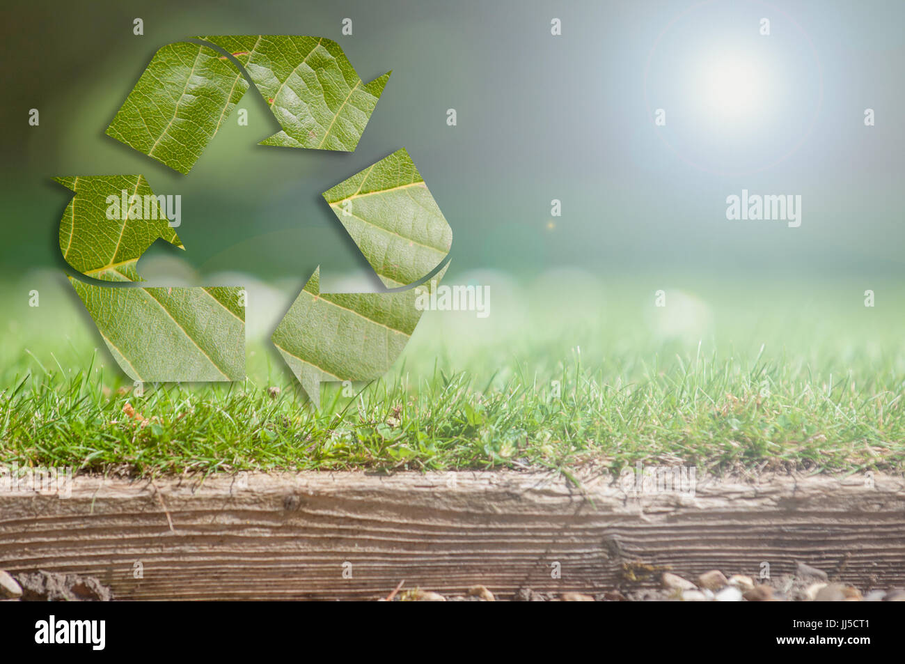 Recycling background with recycle symbol over grass Stock Photo - Alamy