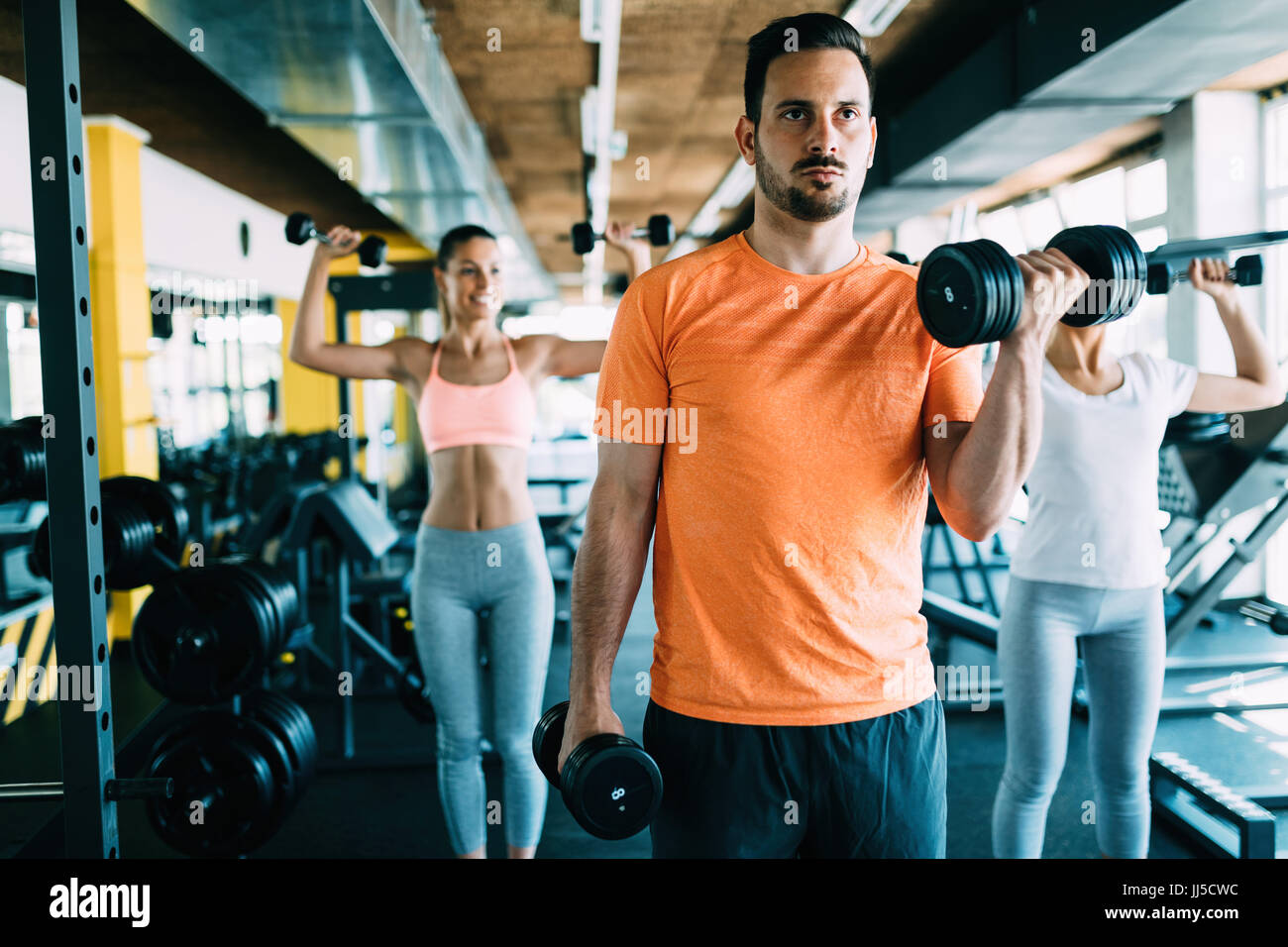 Young attractive man doing exercises in gym Stock Photo - Alamy
