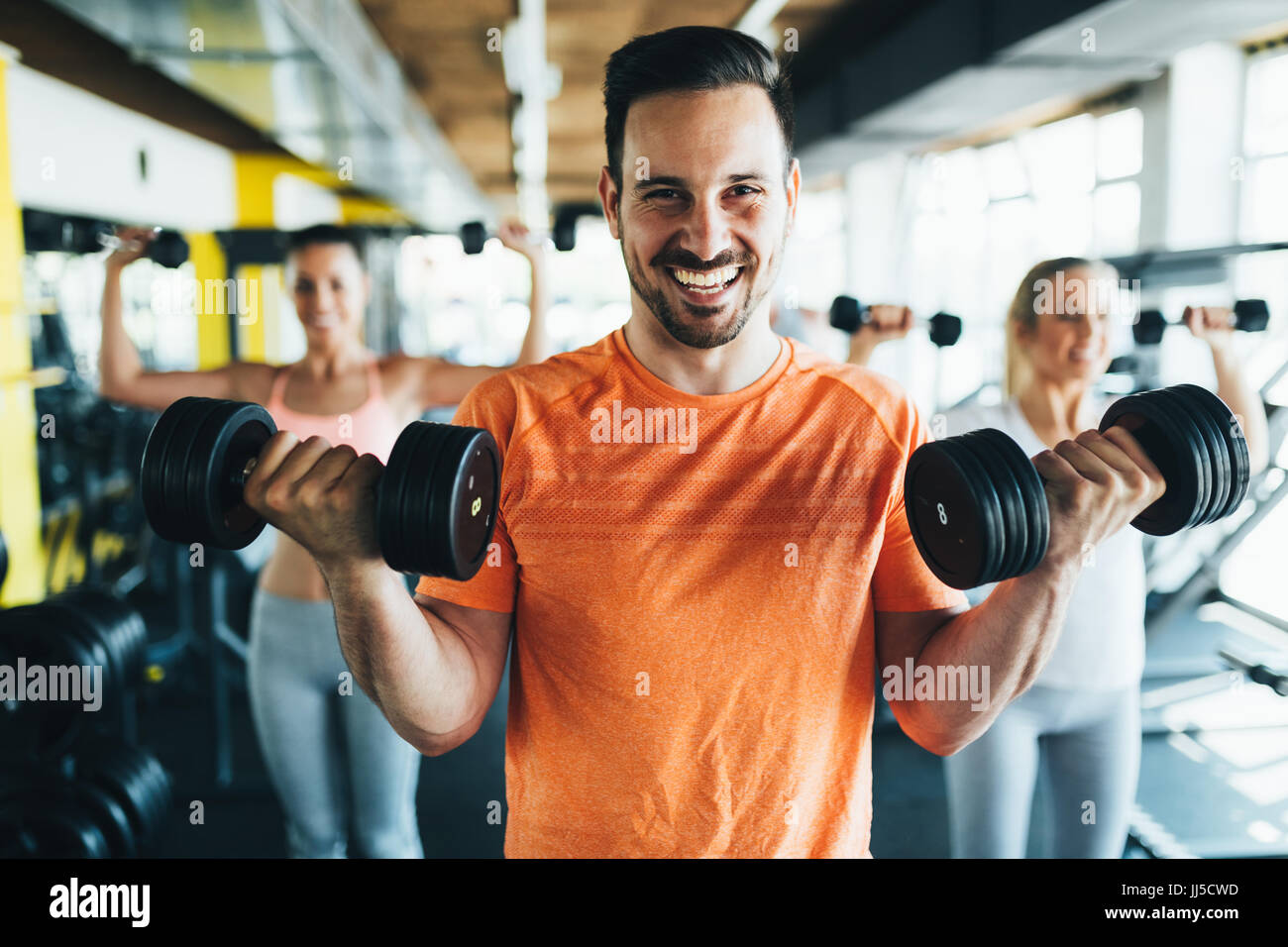 Group of friends exercising together in gym Stock Photo - Alamy