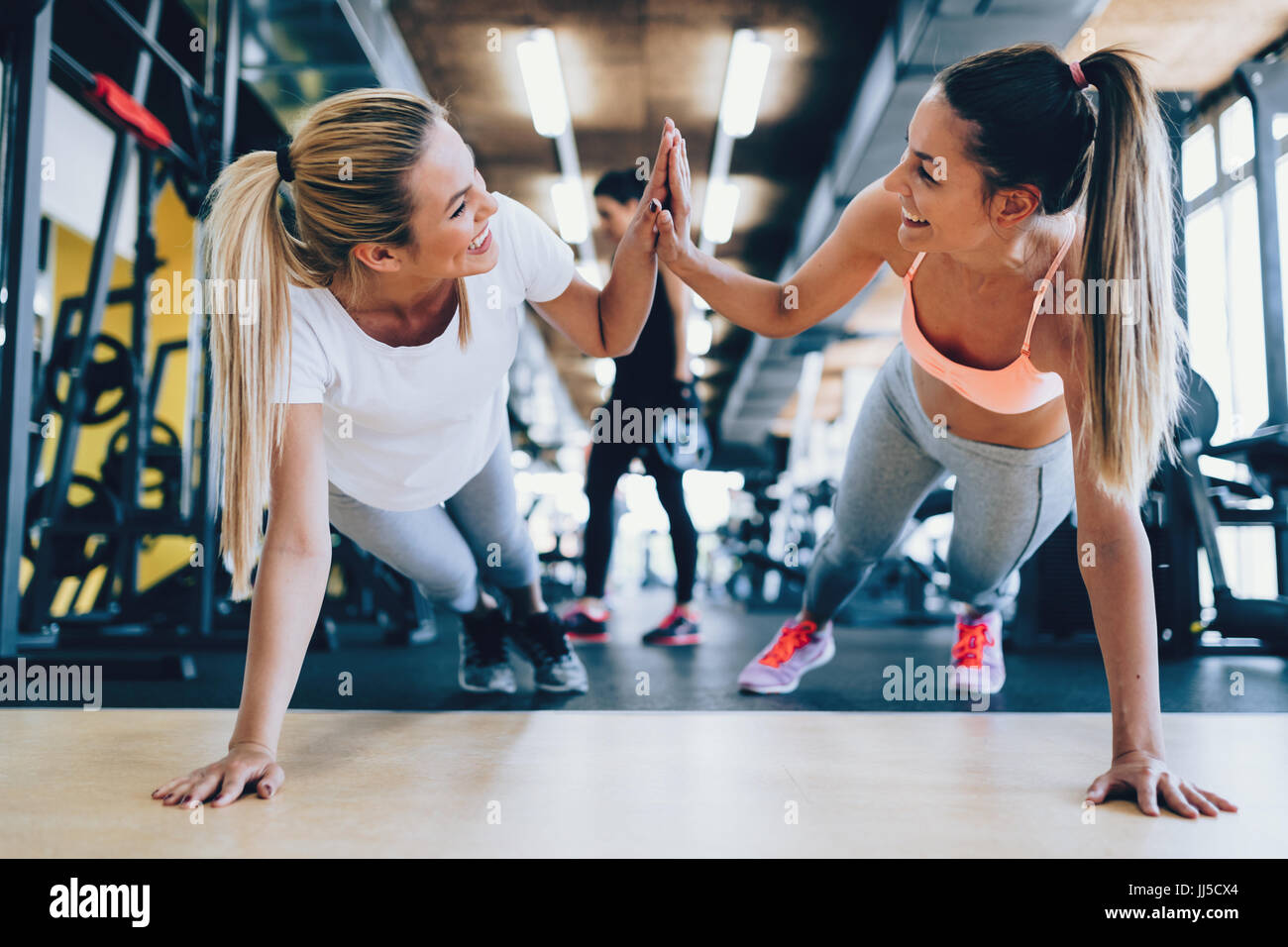 Two attractive fitness girls doing push ups Stock Photo - Alamy