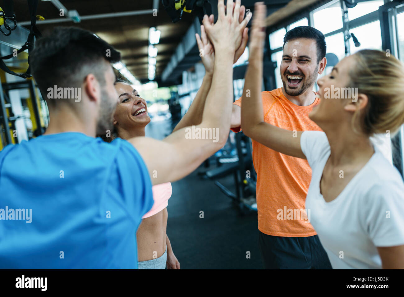 Picture of cheerful fitness team in gym Stock Photo - Alamy