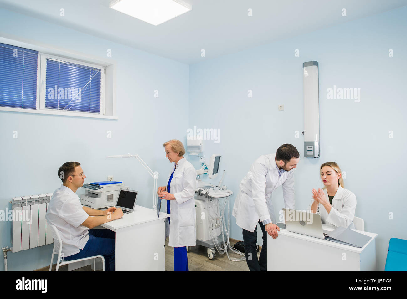 Group Of Doctors Involved In Serious Discussion With Medical Records ...