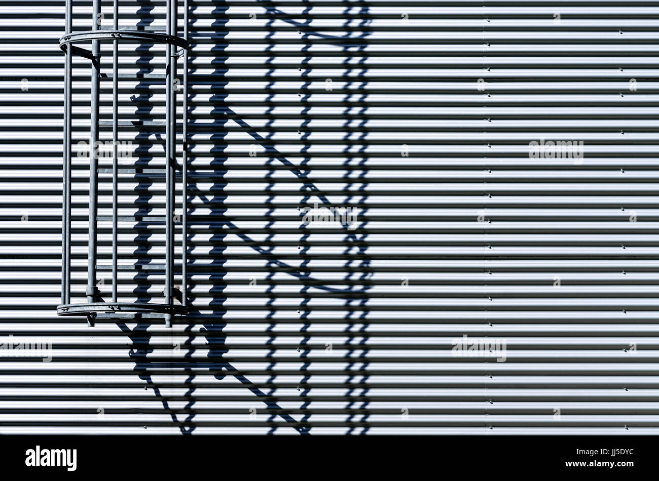 Corrugated metal wall with fire escape ladder Stock Photo - Alamy