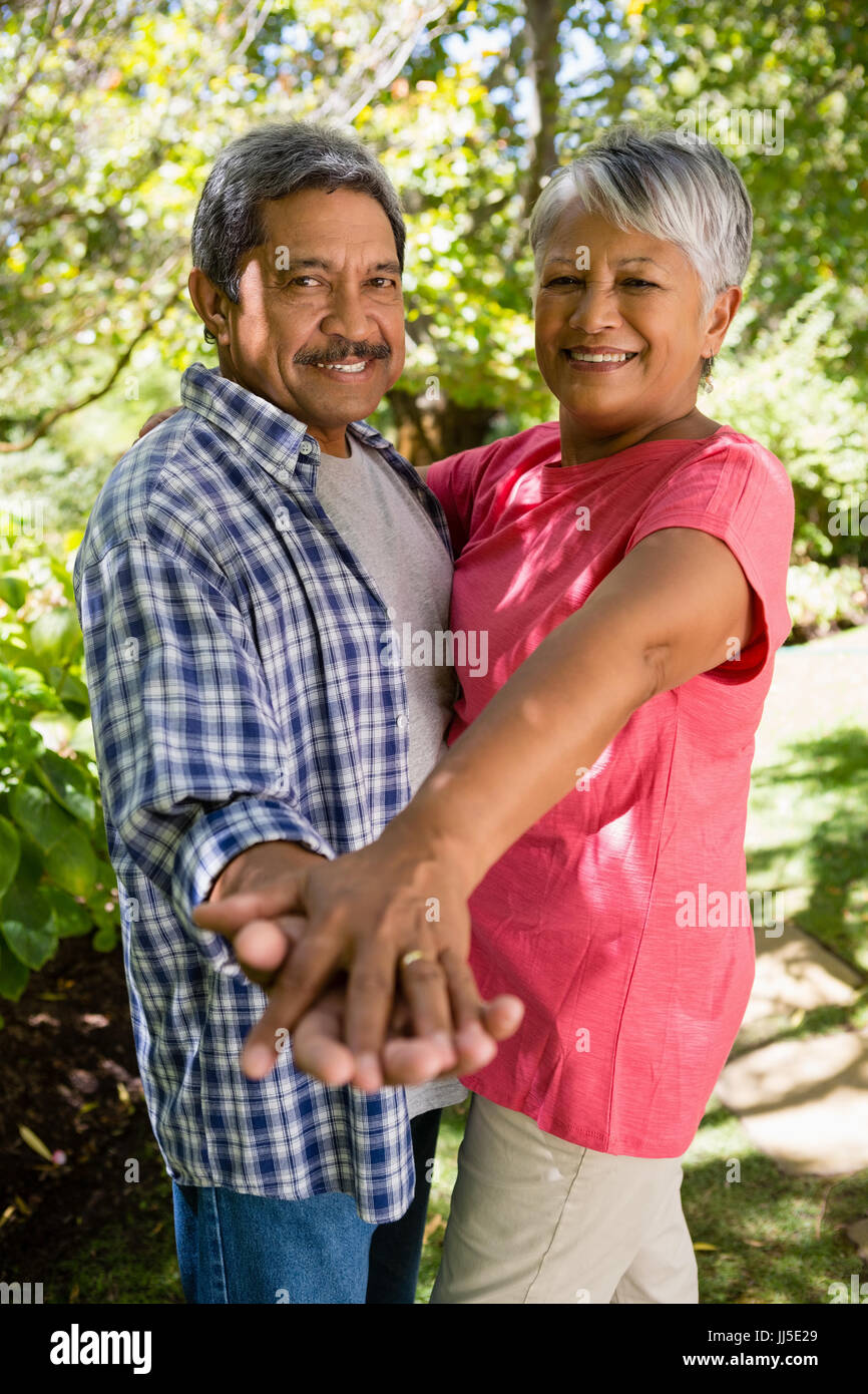 Portrait of happy senior couple dancing in garden on a sunny day Stock ...