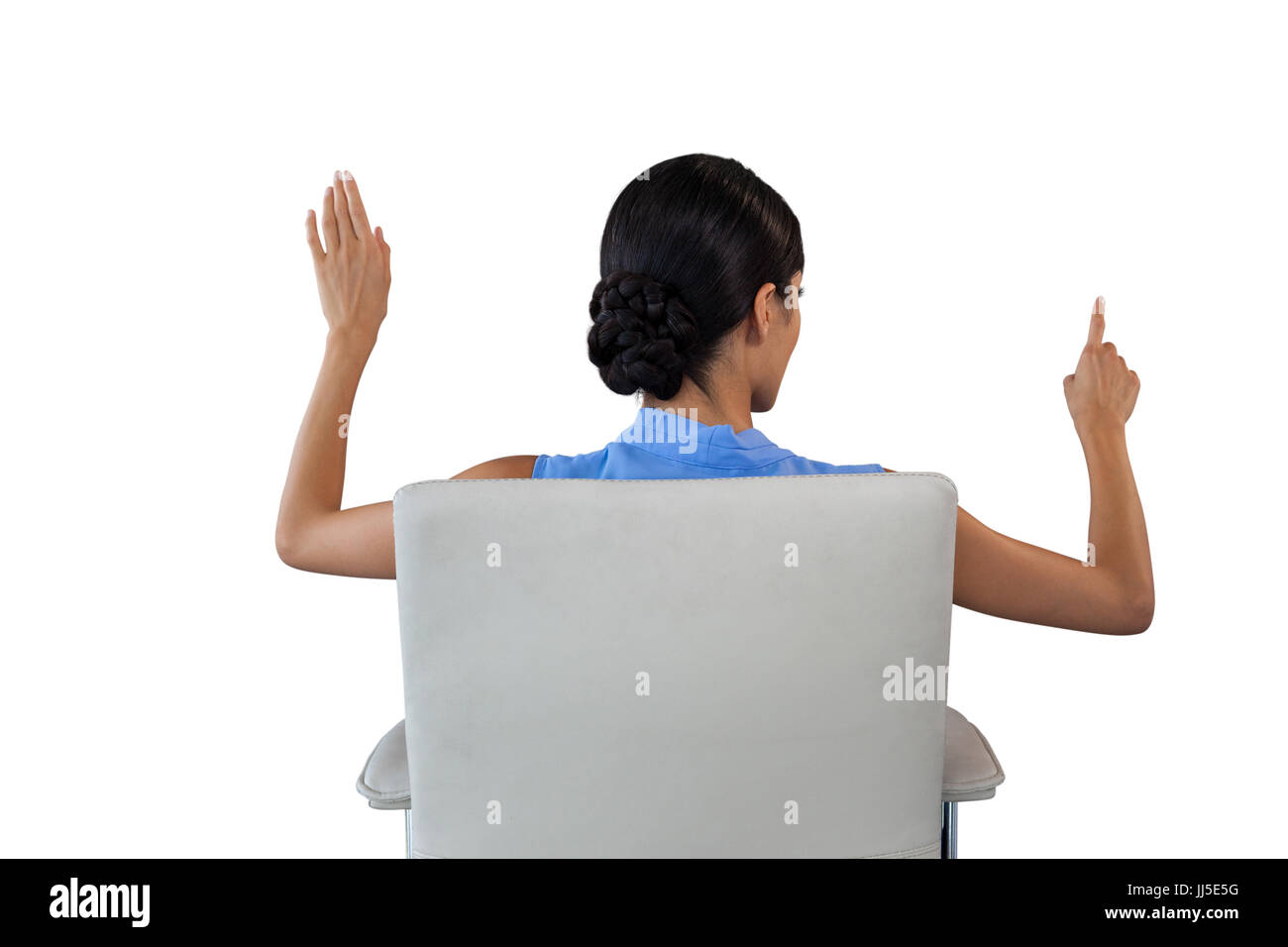 Rear view of businesswoman touching interface white sitting on chair ...