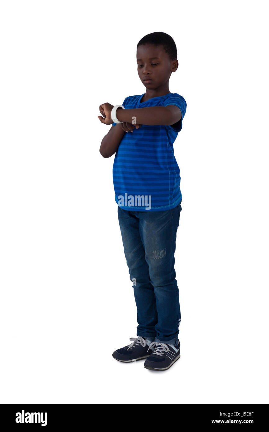 Cute boy operating his smart watch against white background Stock Photo ...