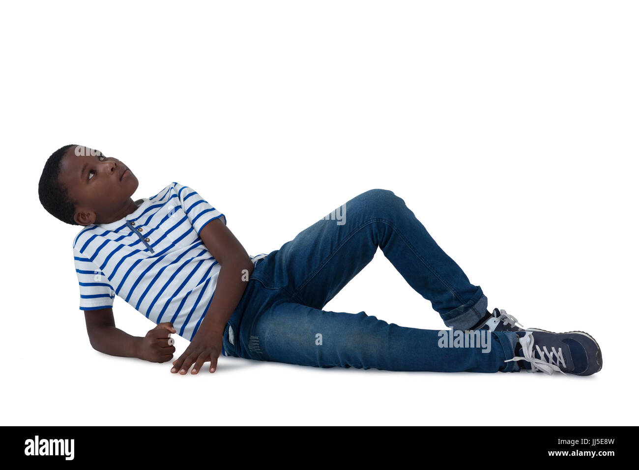 Boy lying on floor against white background Stock Photo - Alamy