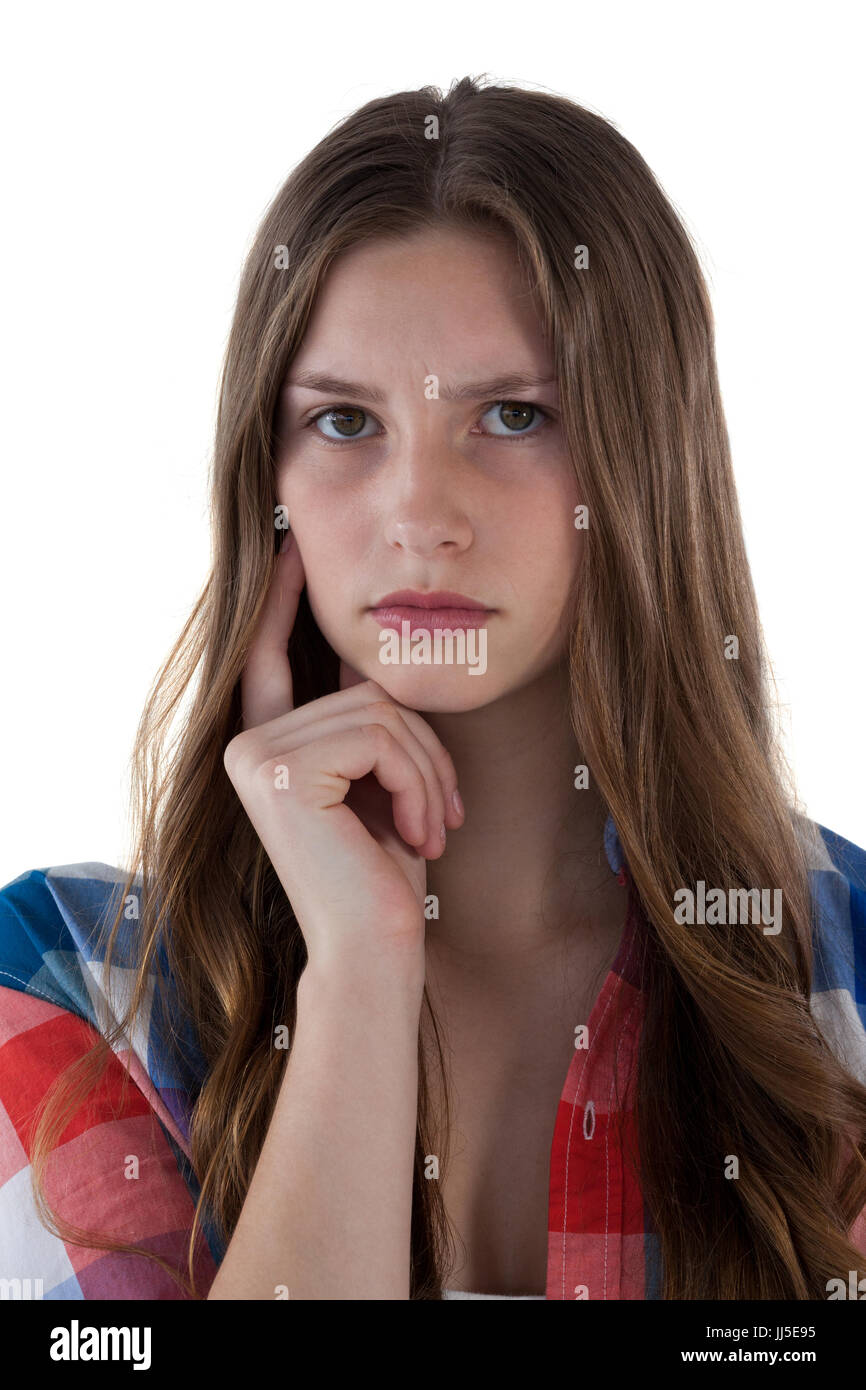 Confused teenage girl standing against white background Stock Photo - Alamy