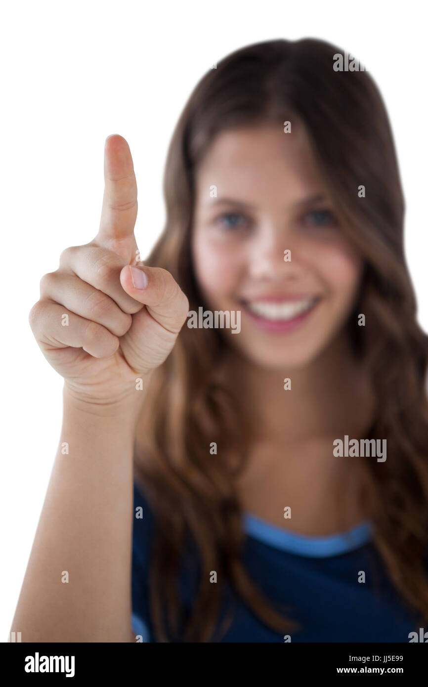 Girl pressing an invisible virtual screen against white background ...