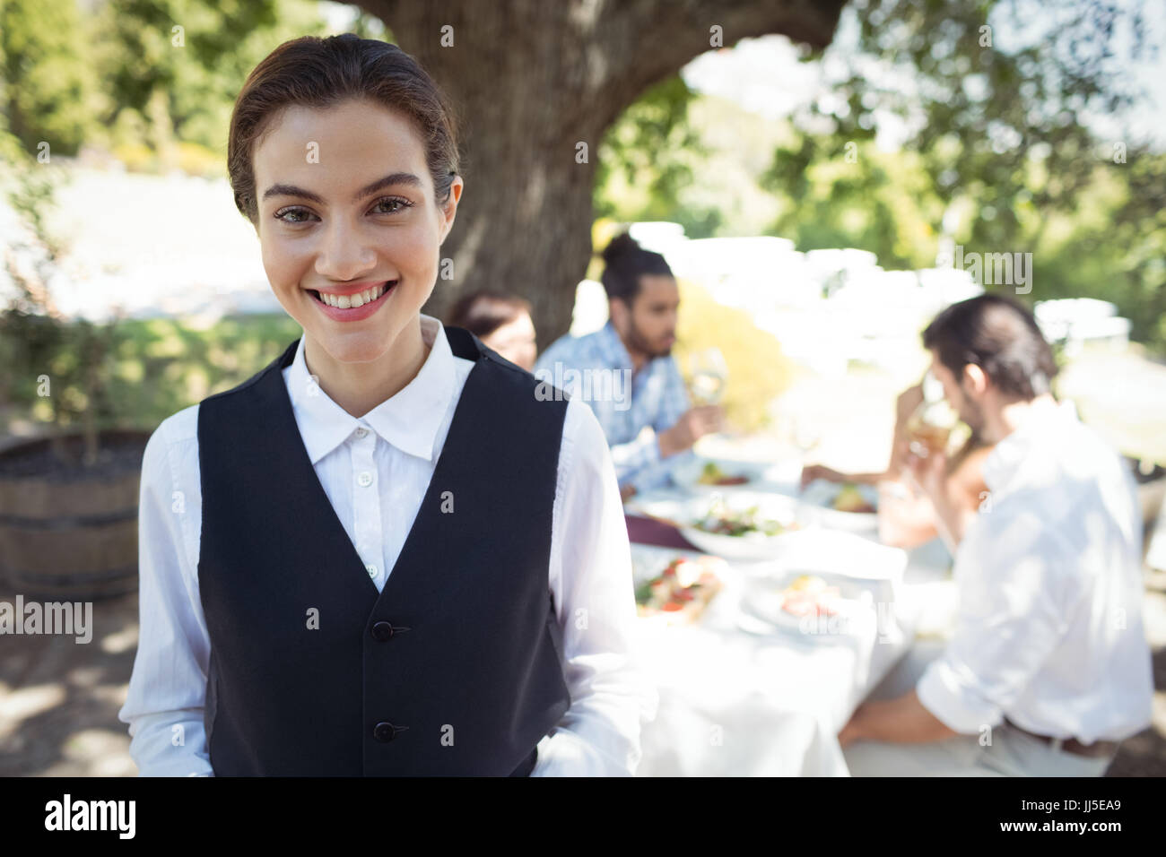 Portrait of smiling waitress in restaurant Stock Photo - Alamy