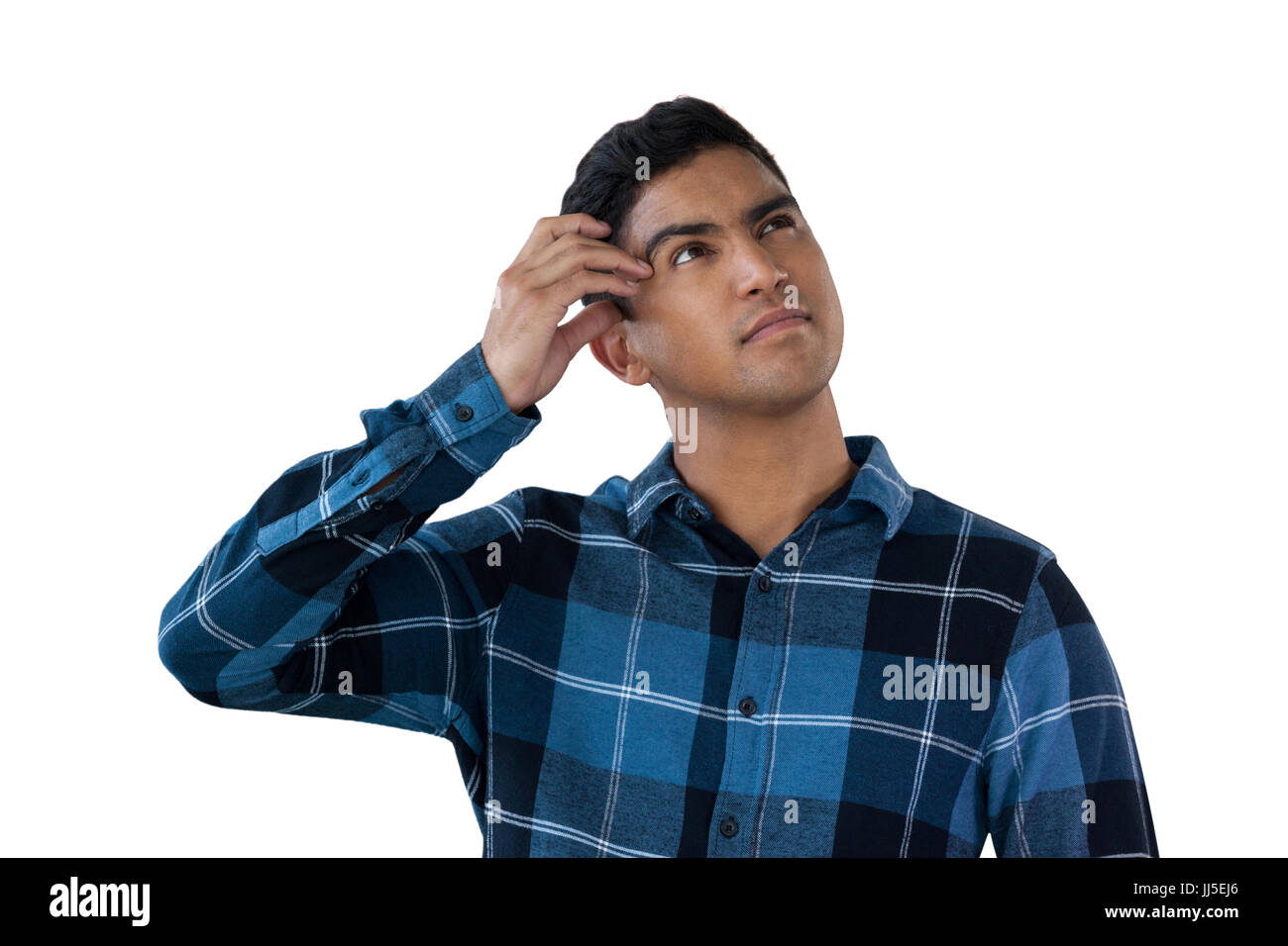 Close up of confused young man against white background Stock Photo - Alamy