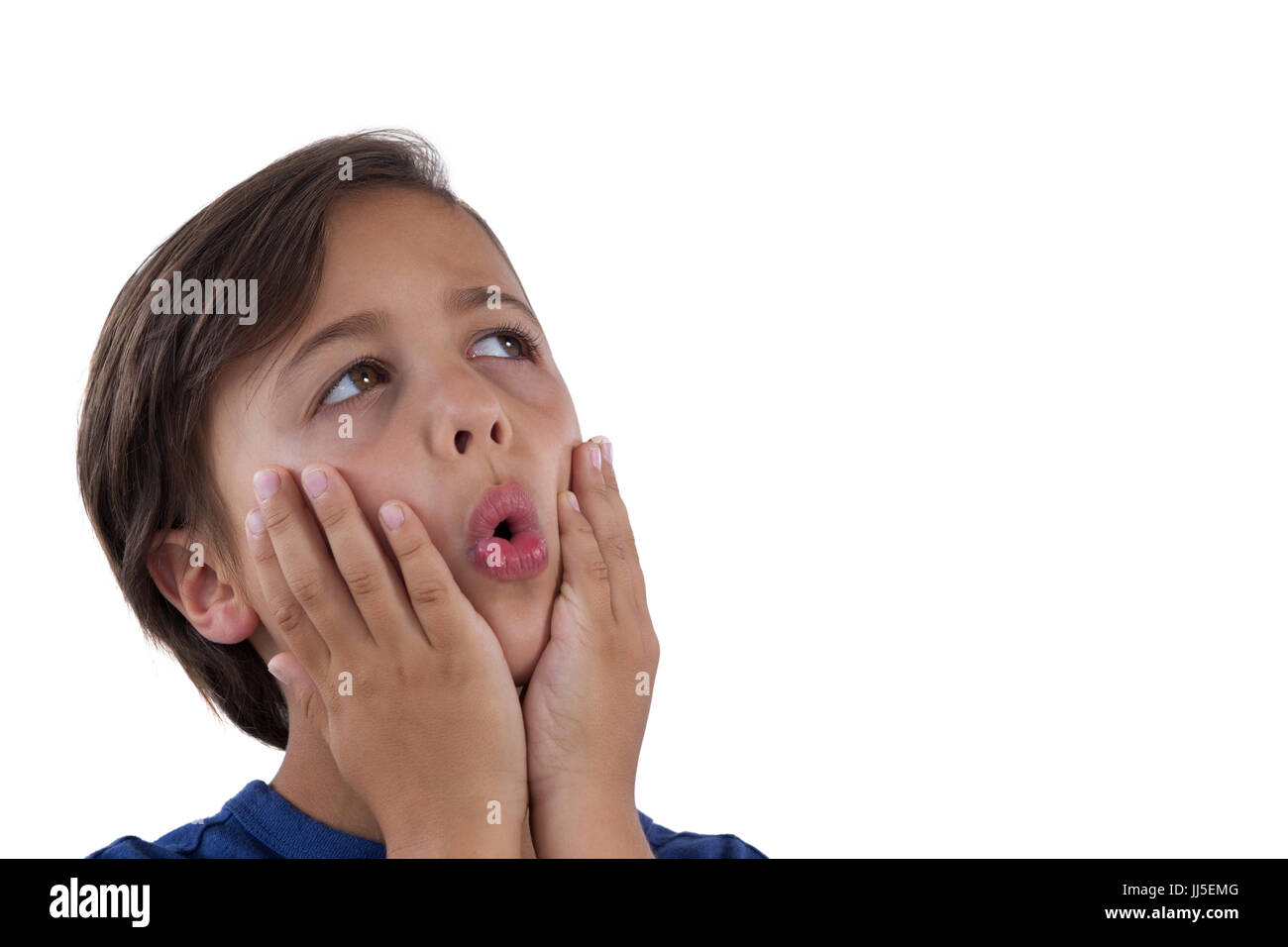 Close-up of shocked boy standing against white background Stock Photo ...
