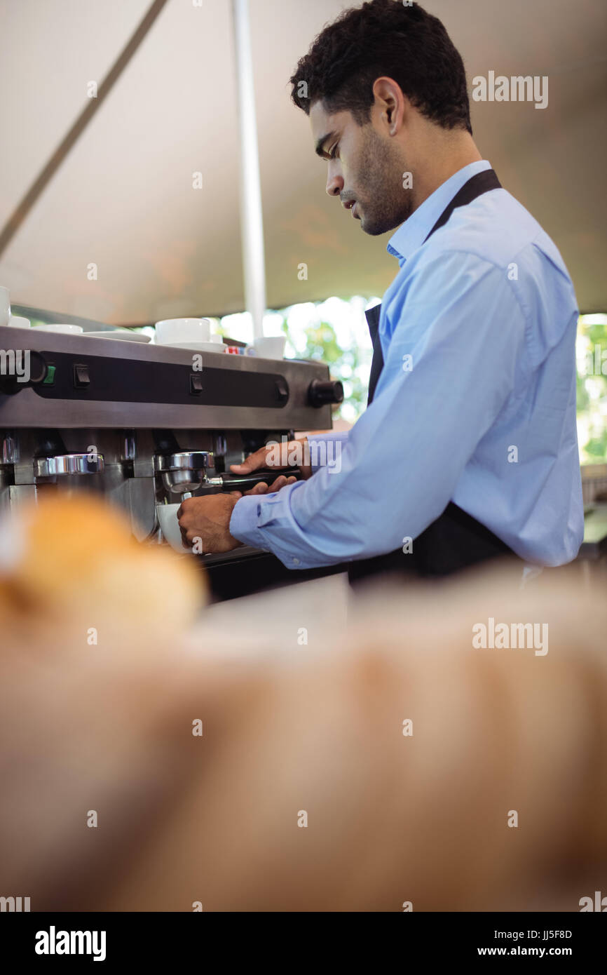 Waiter making cup of coffee from espresso machine in restaurant Stock ...