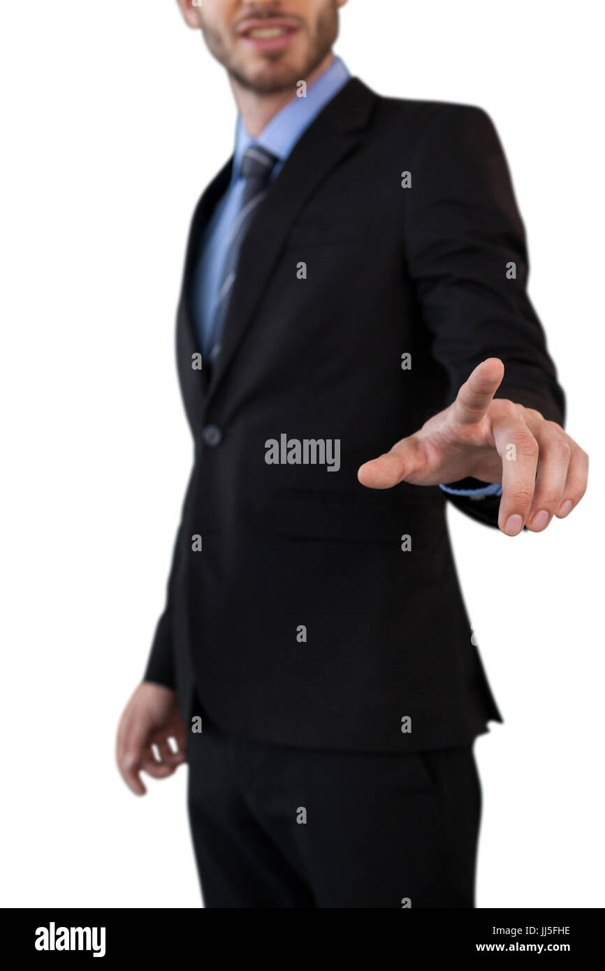 Mid section of businessman in suit touching index finger on invisible ...