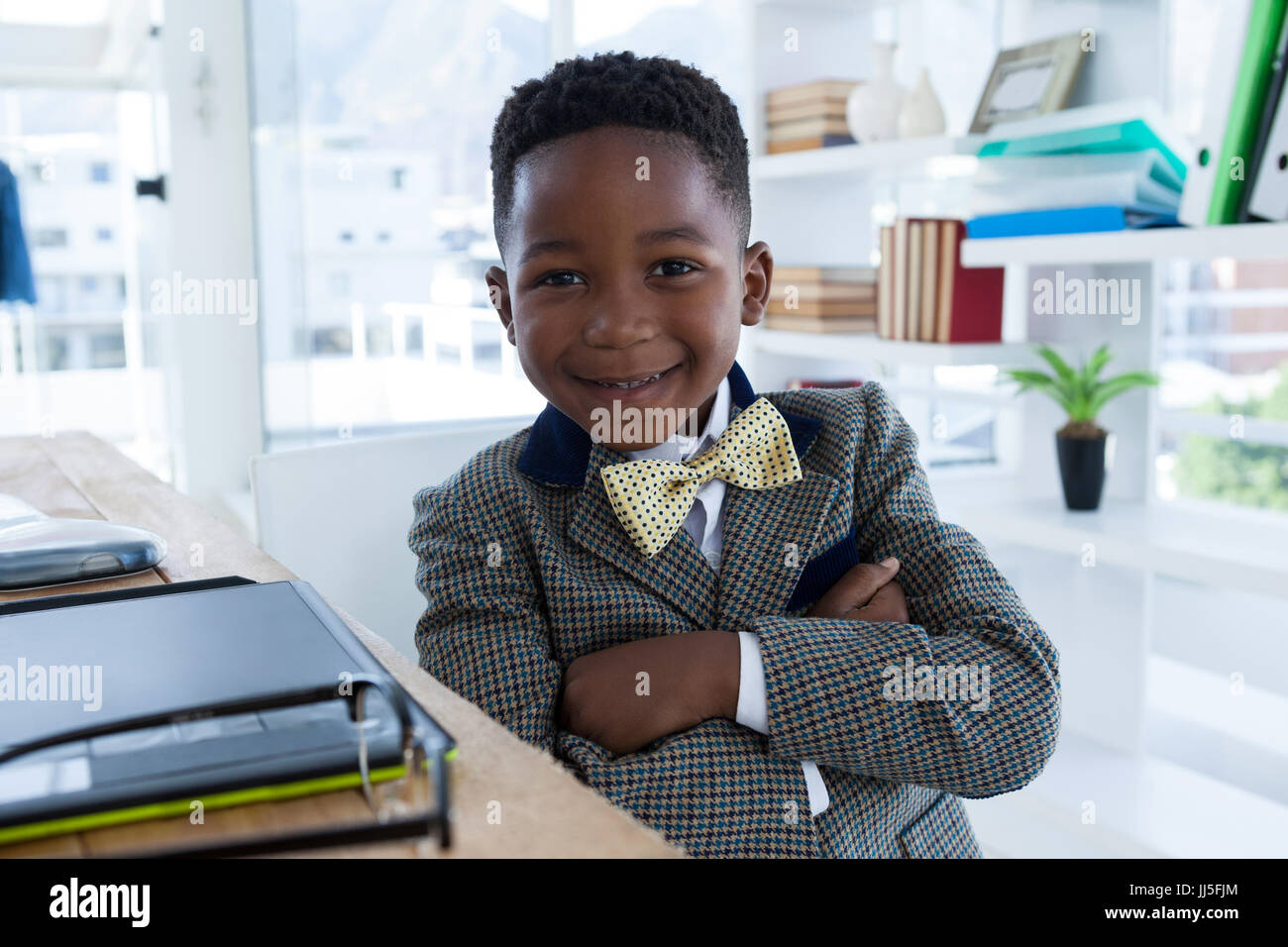 Arms crossed smiling sitting childhood hi-res stock photography and ...