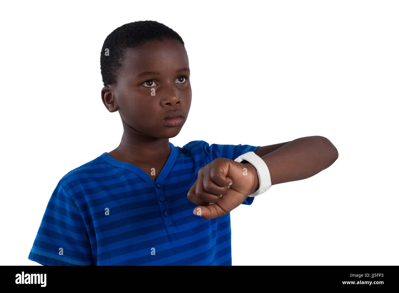 Thoughtful boy with smart watch standing against white background Stock ...