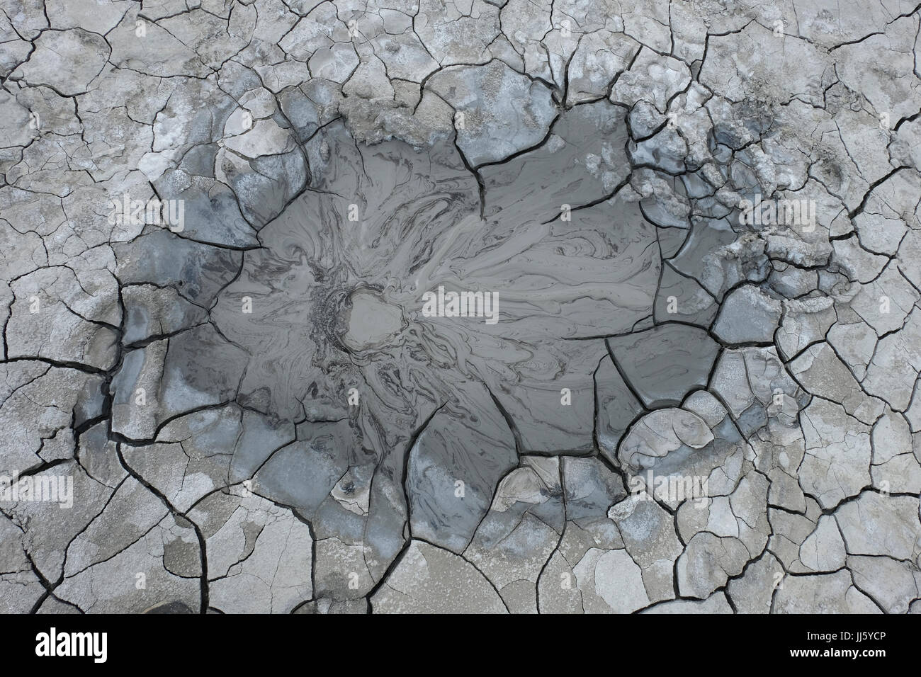 Close up of cracked surface of a mud volcano located in the foothills ...