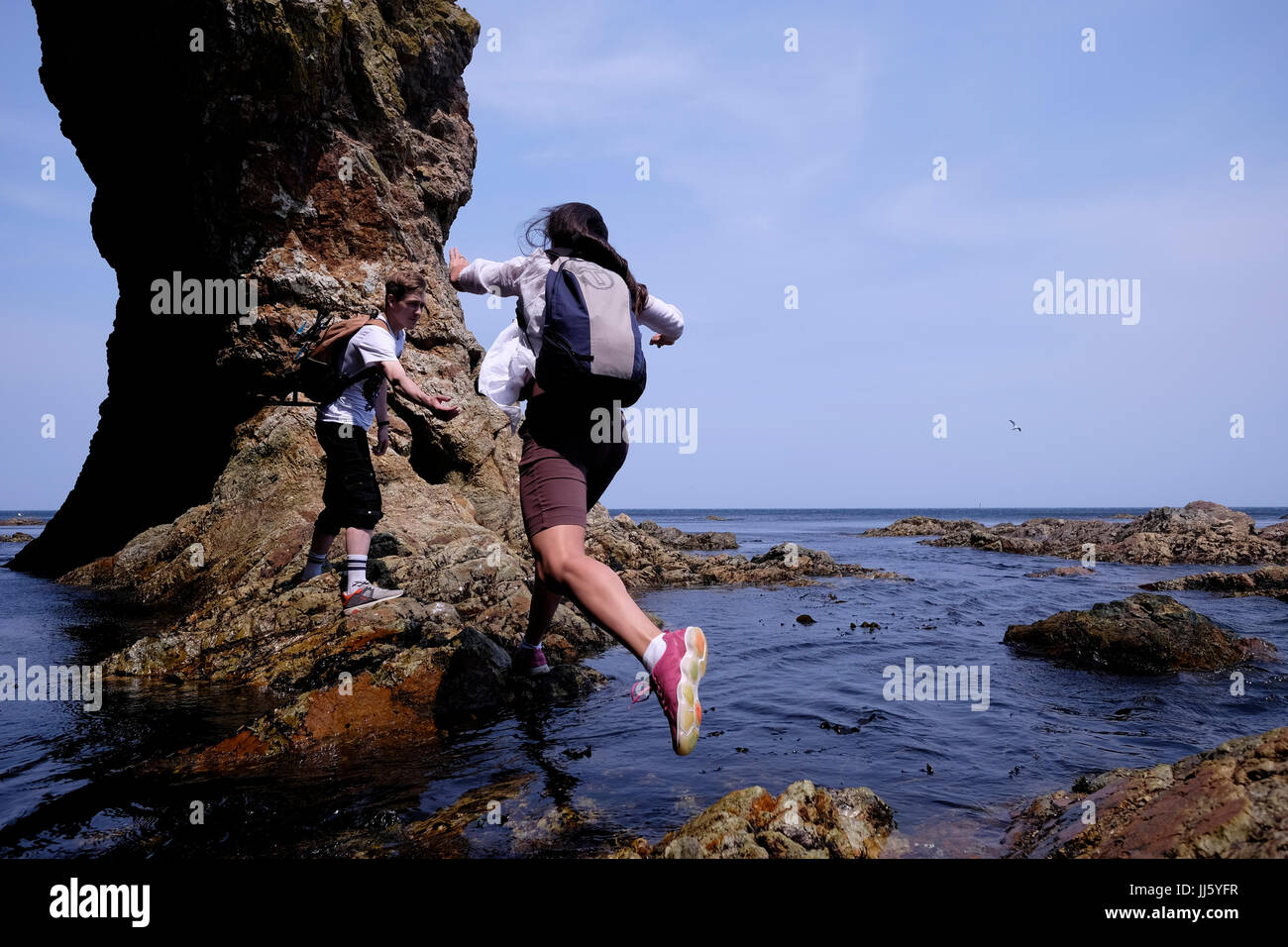 A Russian hiker crossing rock formations in Velikan or Velican Cape ...