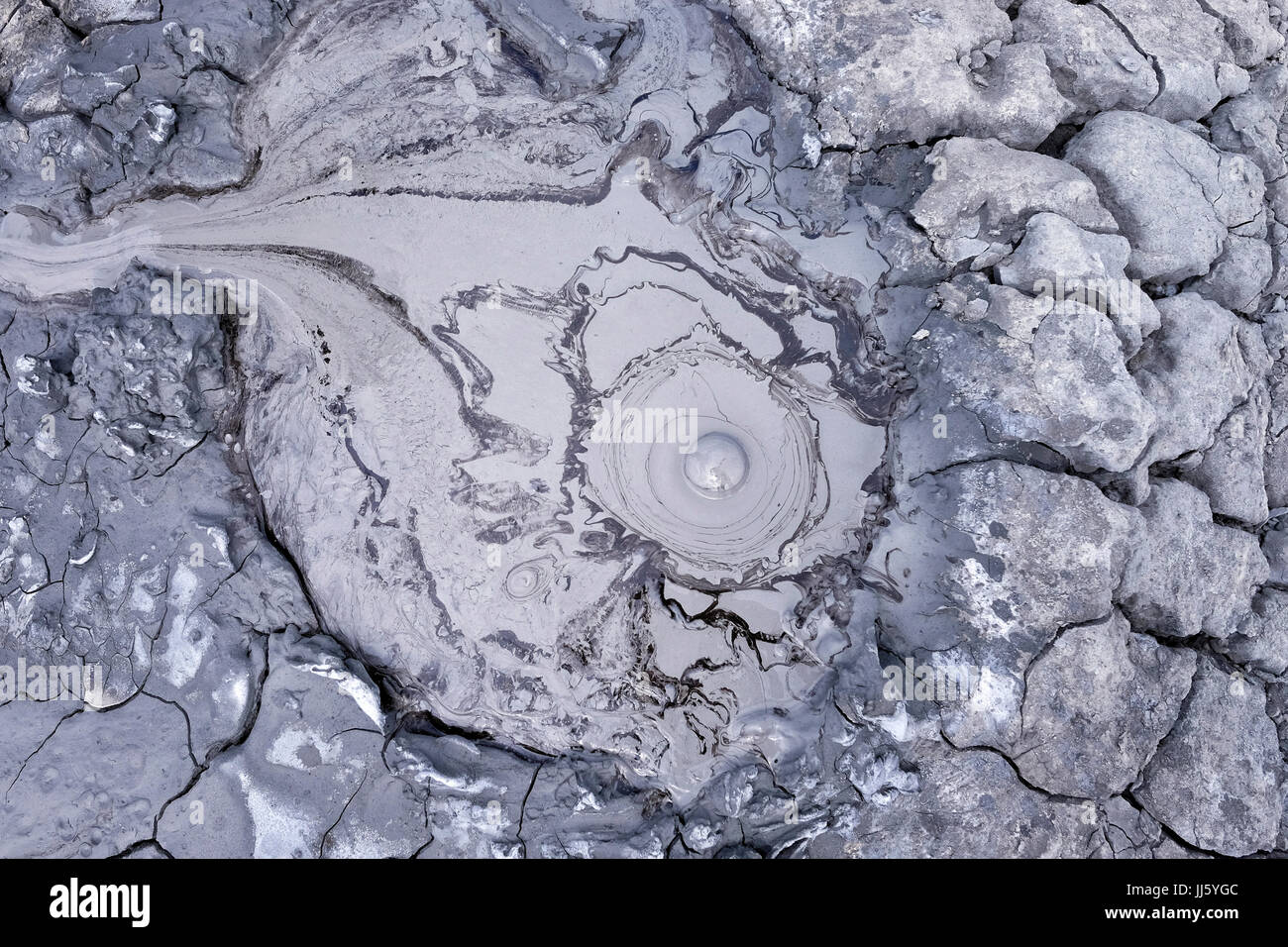 Mud bubbles and erupts from a mud volcano following a build-up of ...