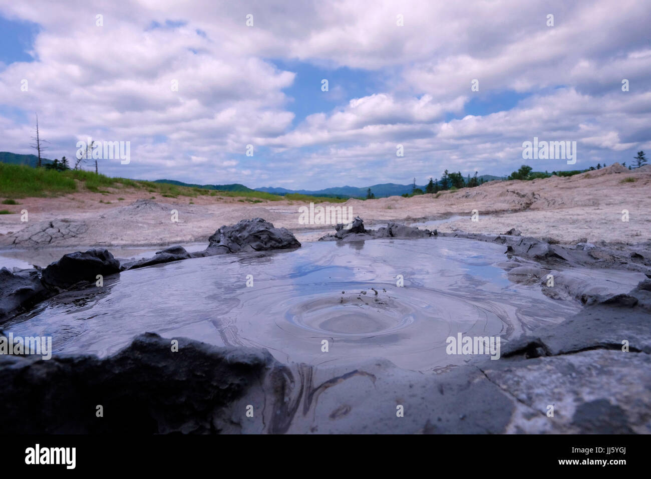 Mud bubbles and erupts from a mud volcano following a build-up of ...