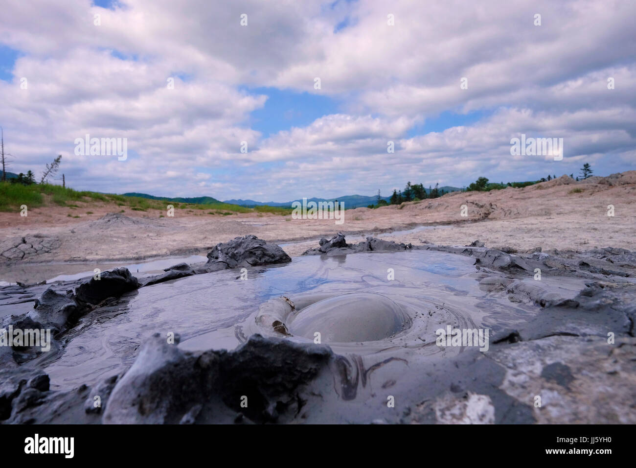 Mud bubbles and erupts from a mud volcano following a build-up of ...