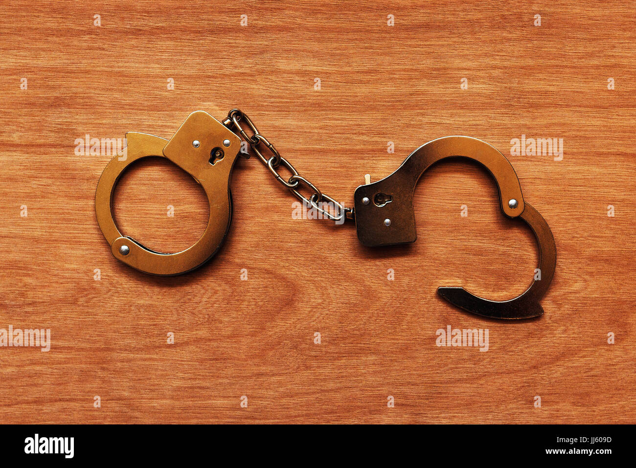 Handcuffs on wooden background, penitentiary and lock up concept Stock ...