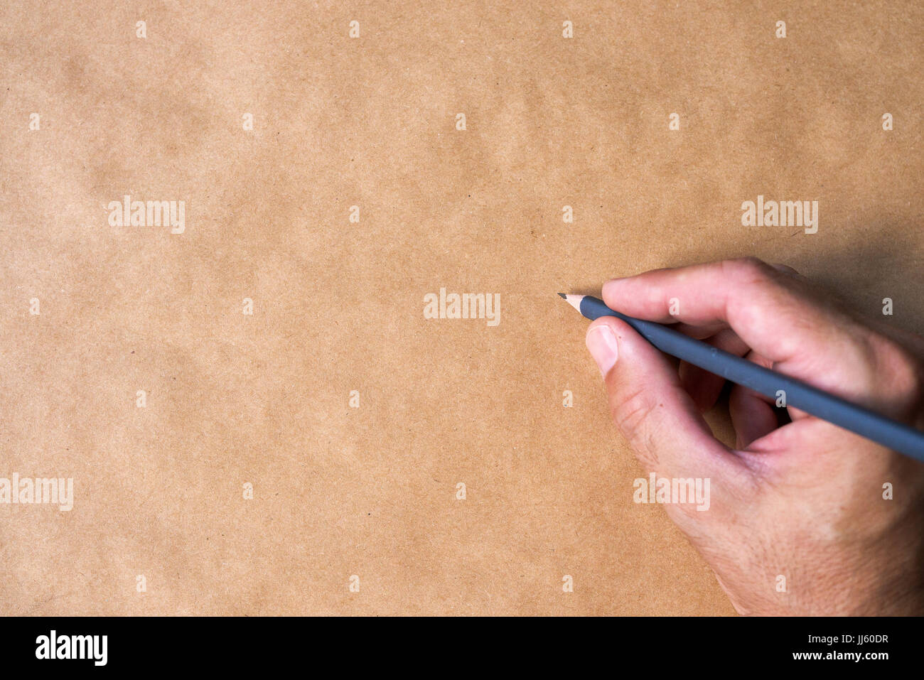 Male illustrator and sketch artist drawing with pencil, top view of ...