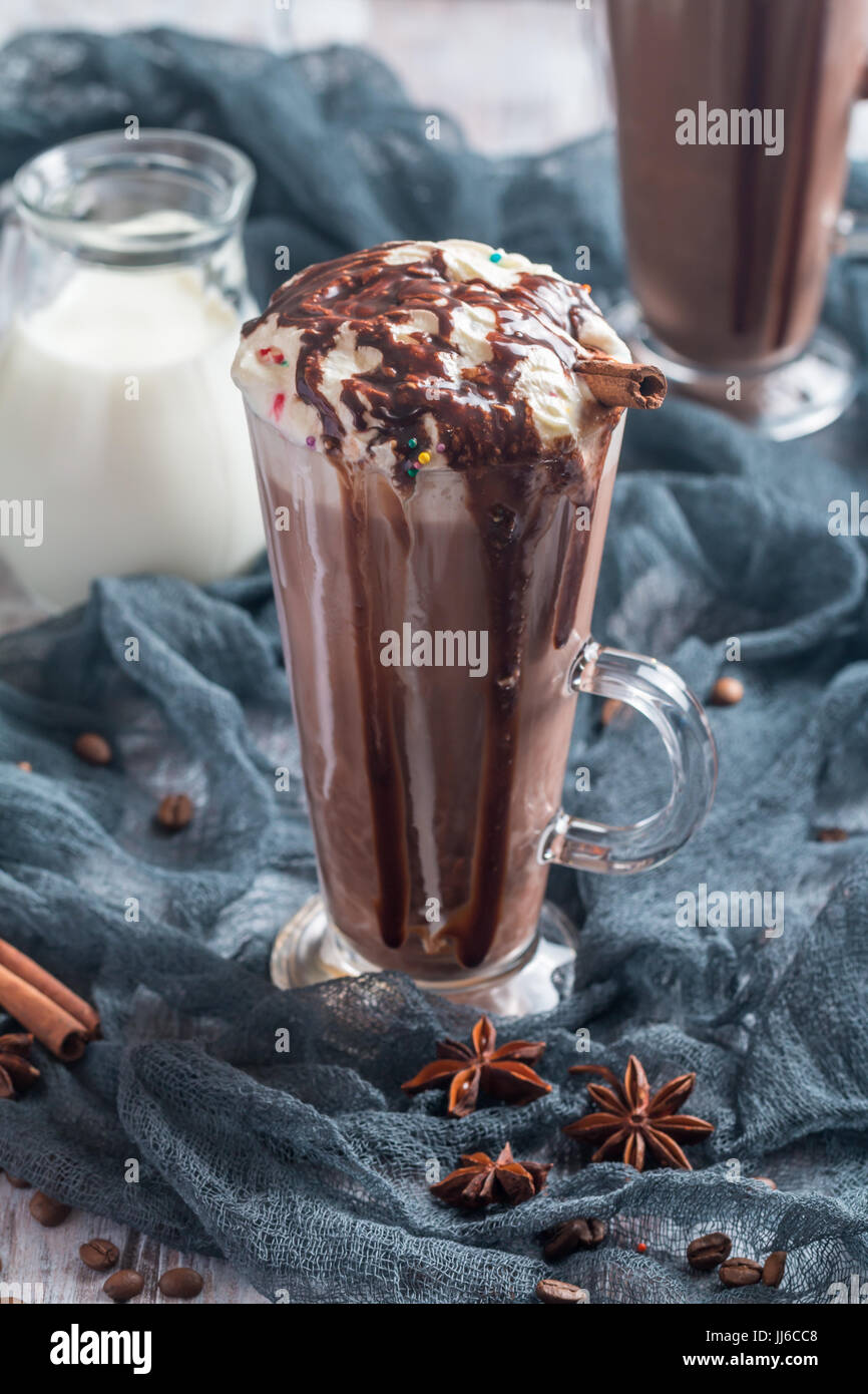 Ice chocolate in tall glass mugs with whipped cream and chocolate sauce ...