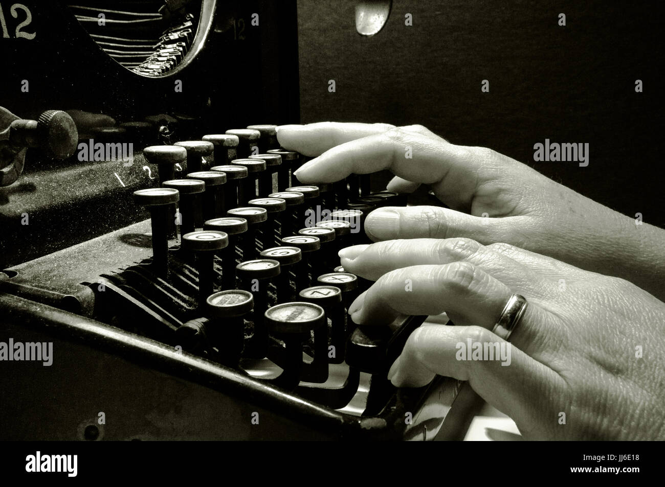 Hands typing on old typewriter keyboard B&W image Stock Photo - Alamy