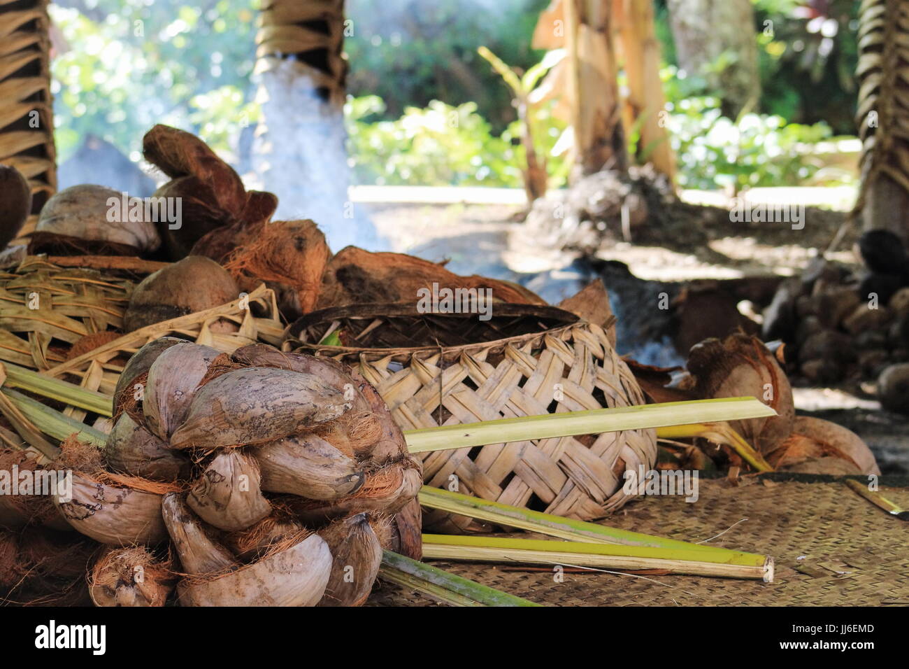 A traditional Samoan cooking area inside a hut with woven baskets and ...