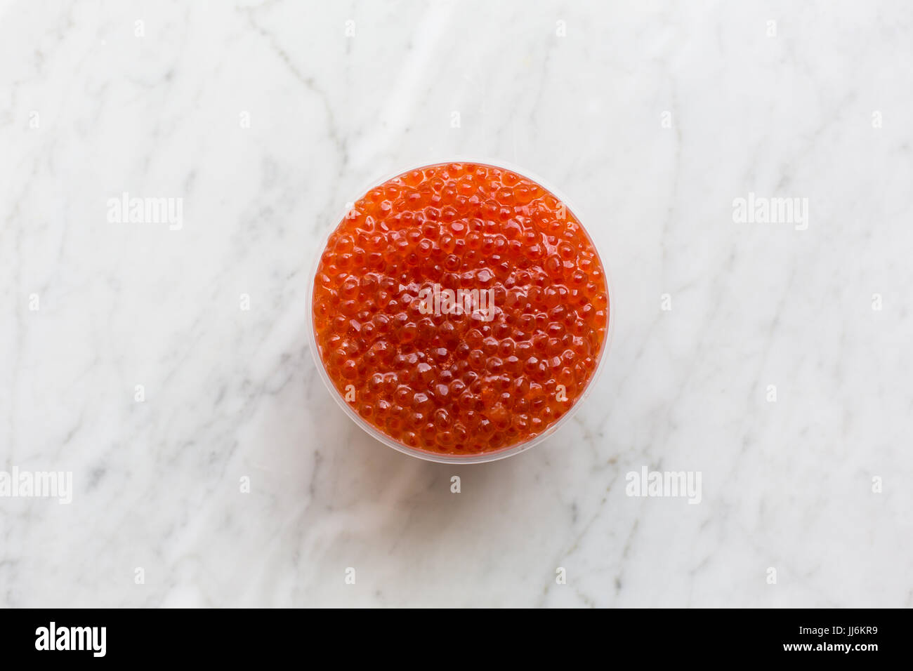 Top view of red caviar in a bowl on a light marble background Stock ...