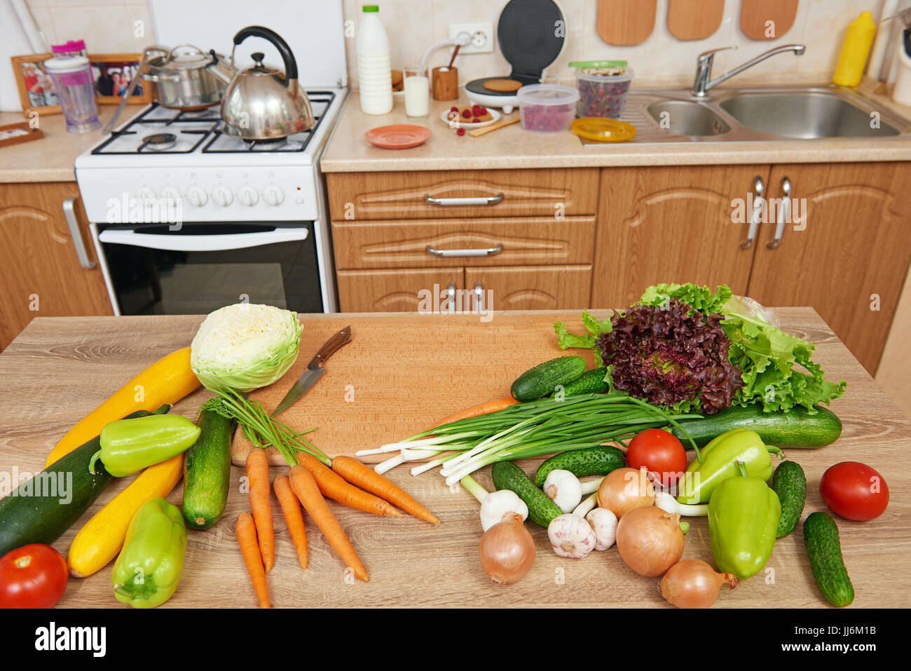 kitchen interior with fresh fruits and vegetables on the table, healthy ...