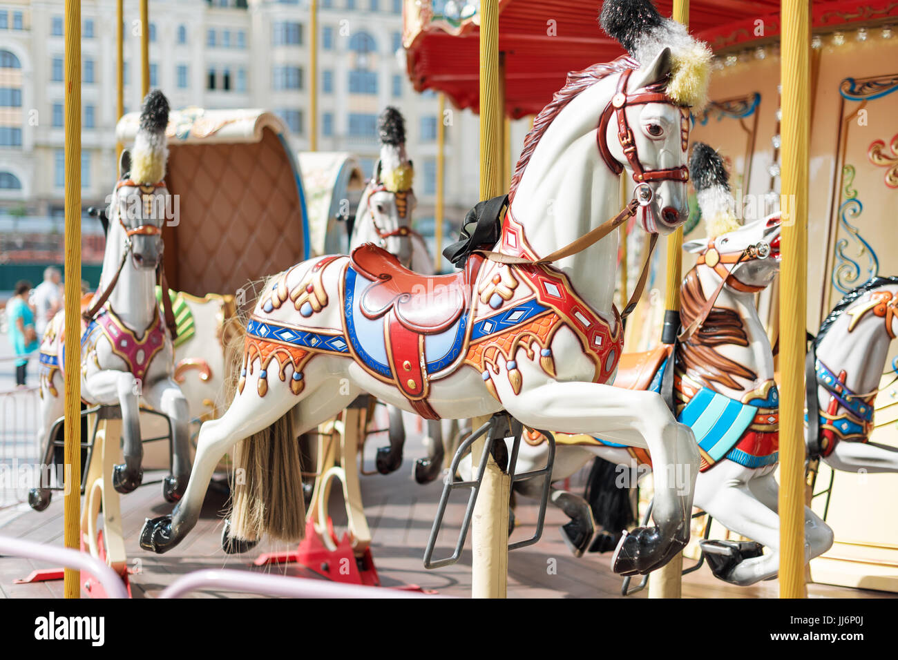 Horses on a carnival Merry Go Round. Old French carousel in a holiday ...