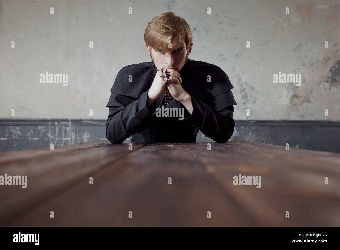 Portrait of handsome young catholic priest looking at you. Prayer Stock ...