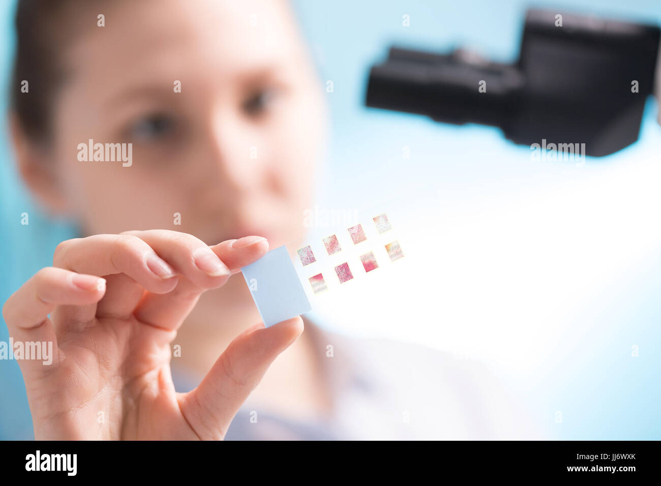Microscope slide in hand Stock Photo - Alamy