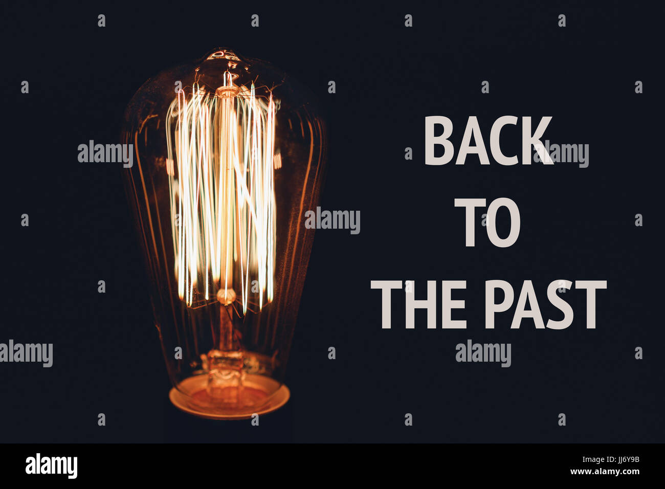 Inscription Back to the past on the image of retro bulb on a black ...