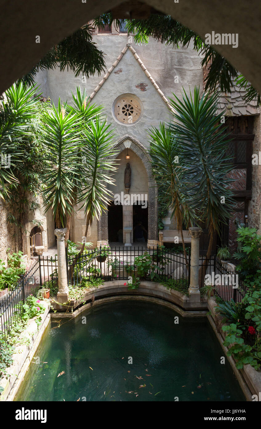 Indoor courtyard at Hammond Castle, in Gloucester, Massachusetts. The pathway around the pool ...