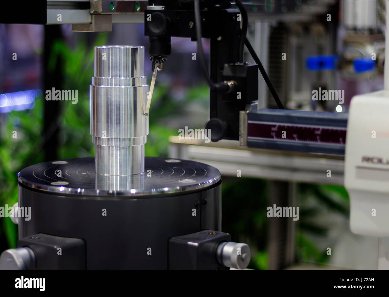 Roundness tester measuring workpiece on turntable ;focus in stylus ...