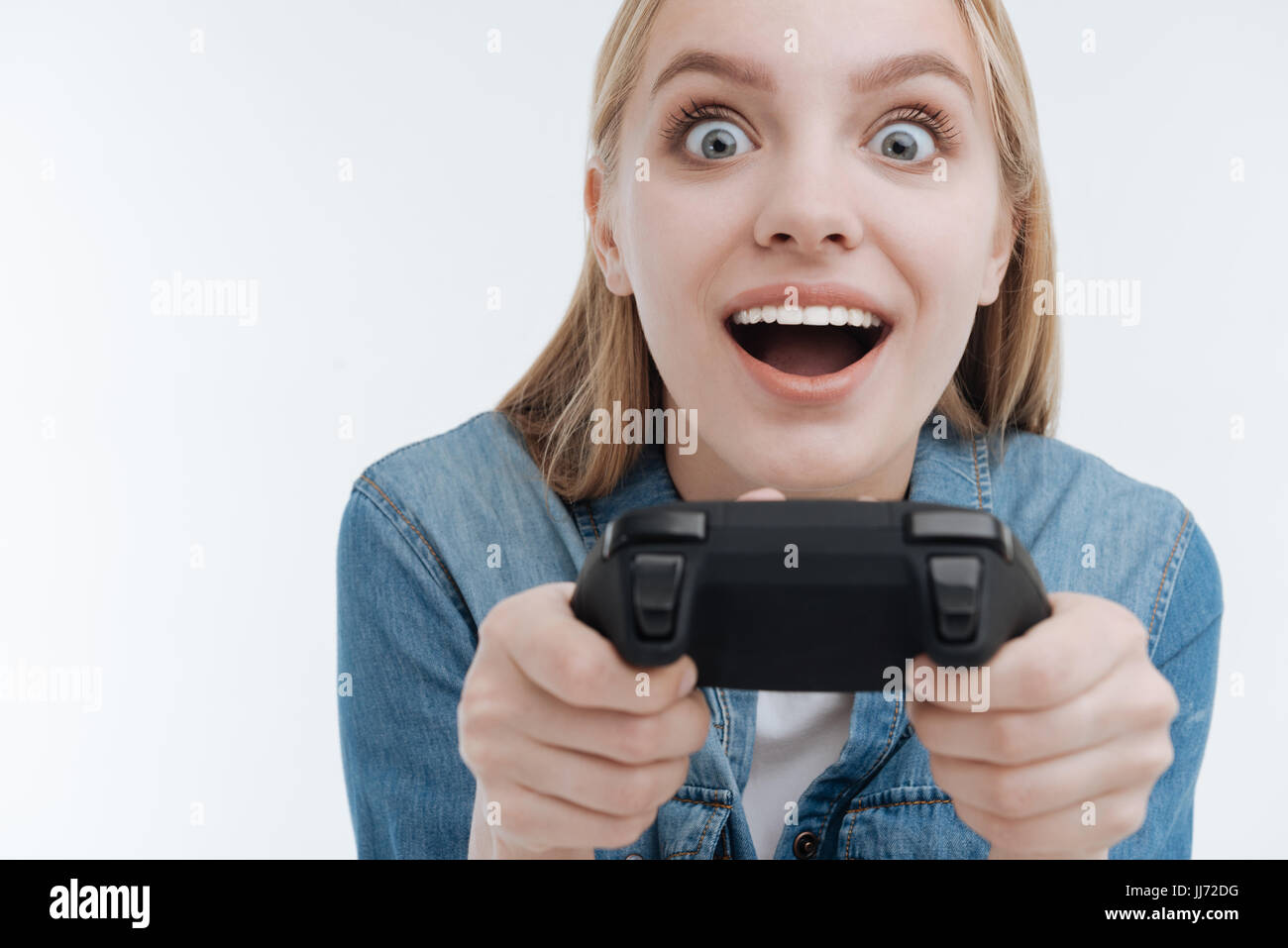 Shocked girl playing interesting game Stock Photo - Alamy