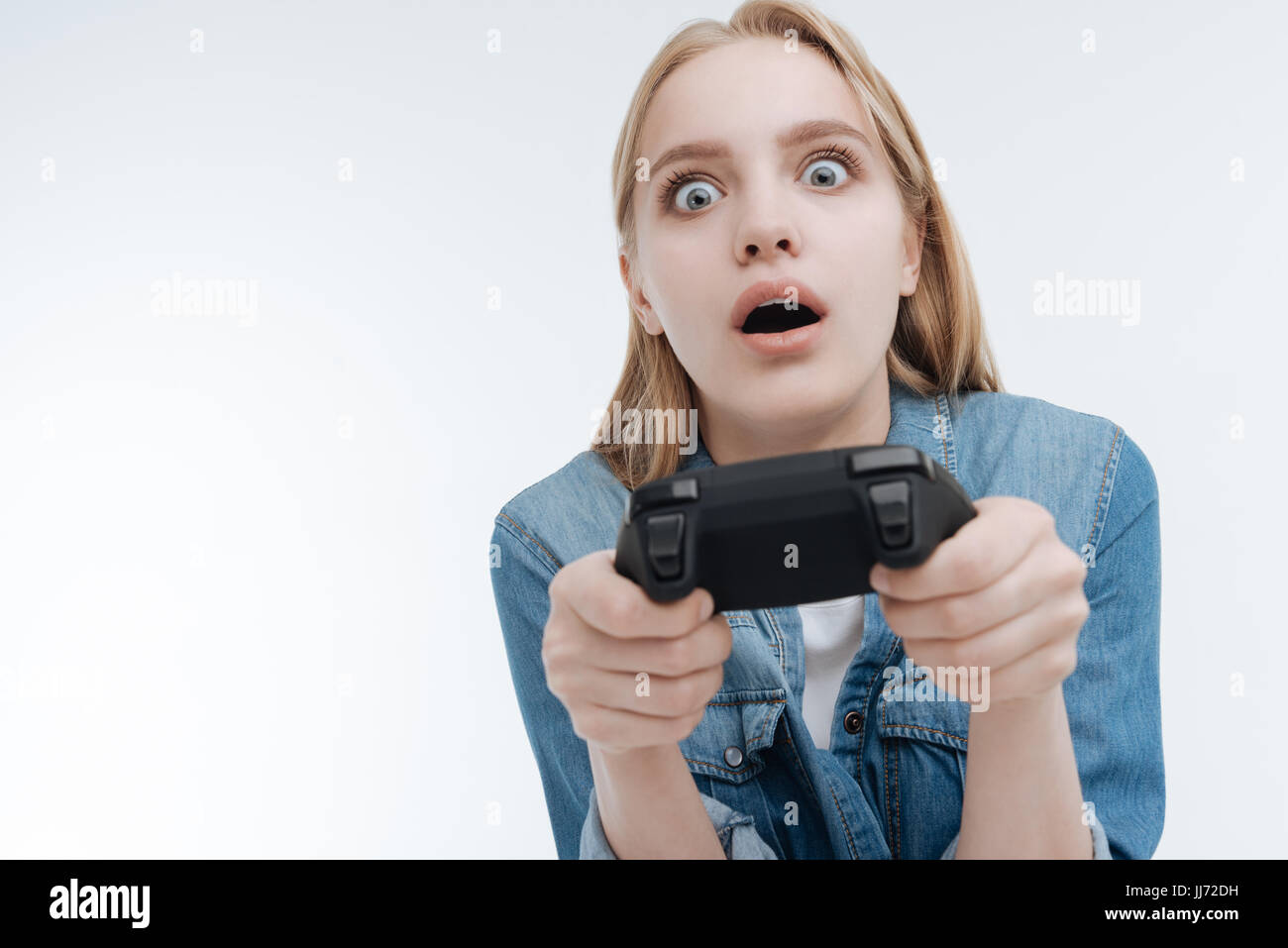 Surprised young woman looking forward Stock Photo - Alamy