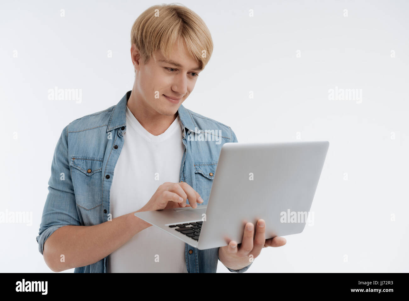 Attentive man looking at screen of his computer Stock Photo - Alamy