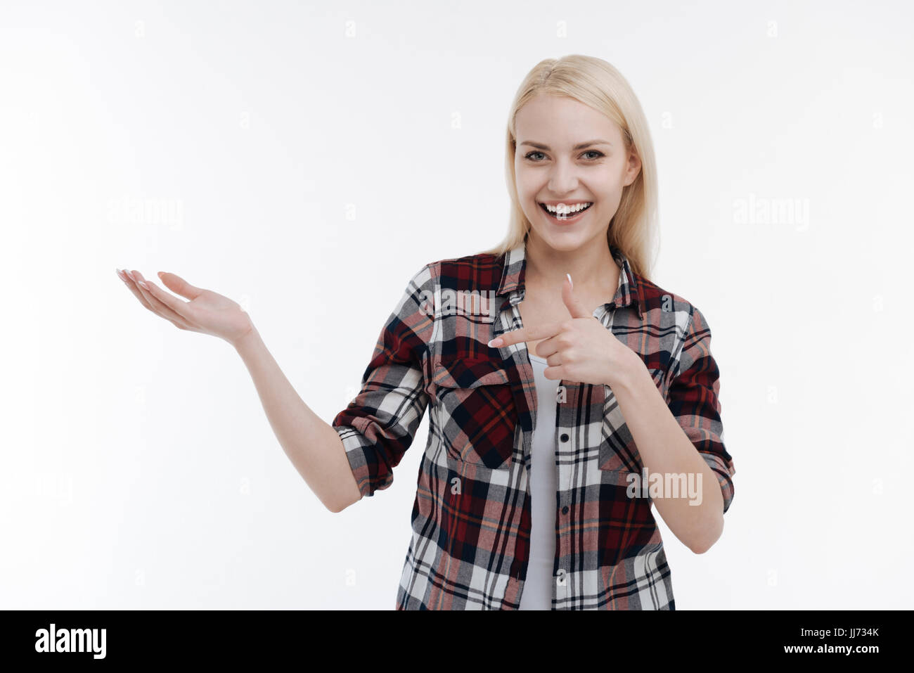 Attractive female pointing at her right hand Stock Photo - Alamy