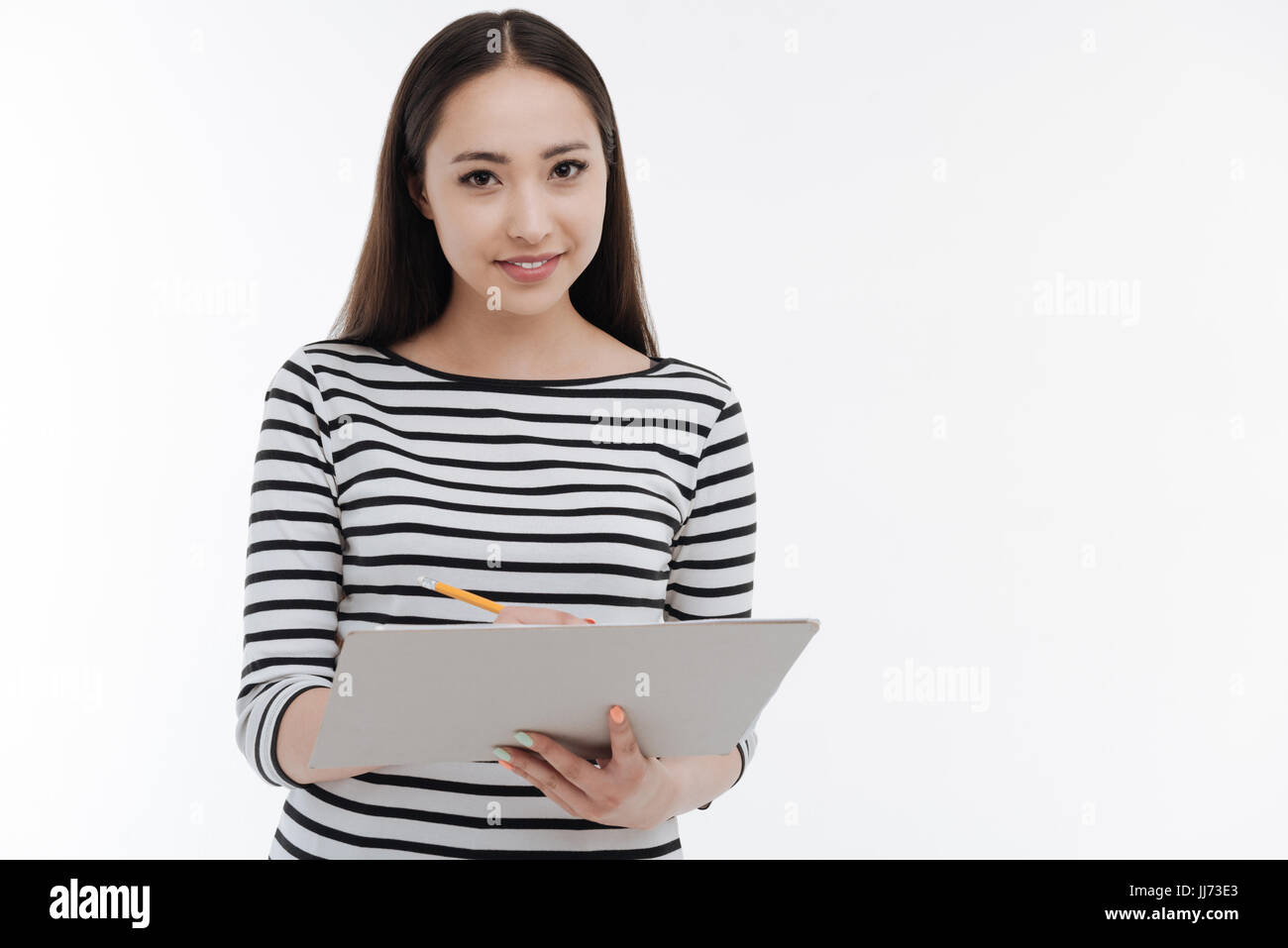 Attractive young woman making some notes Stock Photo - Alamy