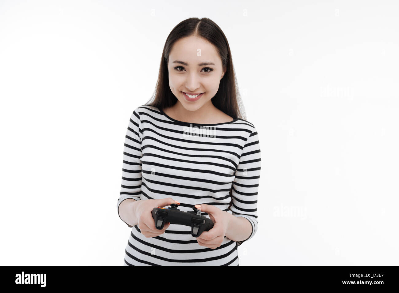 Beautiful girl playing with game console Stock Photo - Alamy
